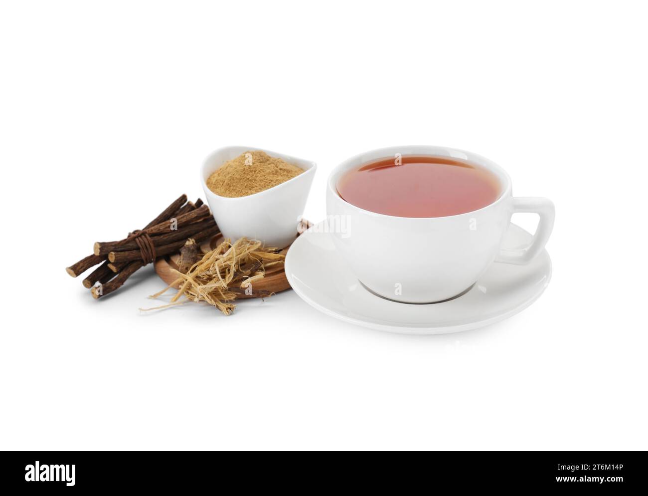 Aromatic licorice tea in cup, dried sticks of licorice root and powder ...