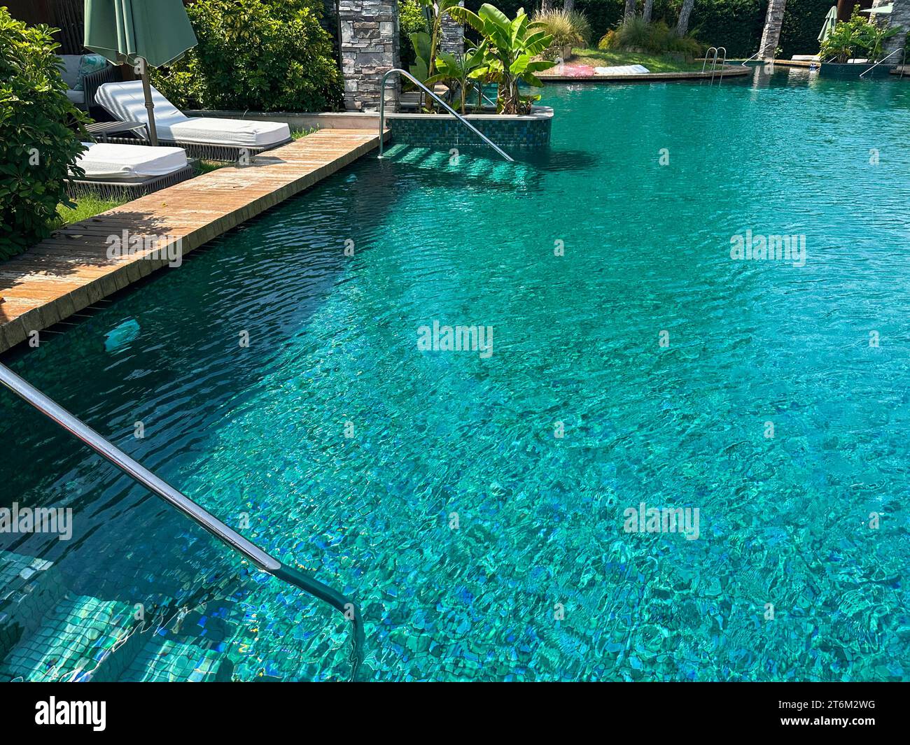 Metal rail and steps in outdoor swimming pool Stock Photo - Alamy