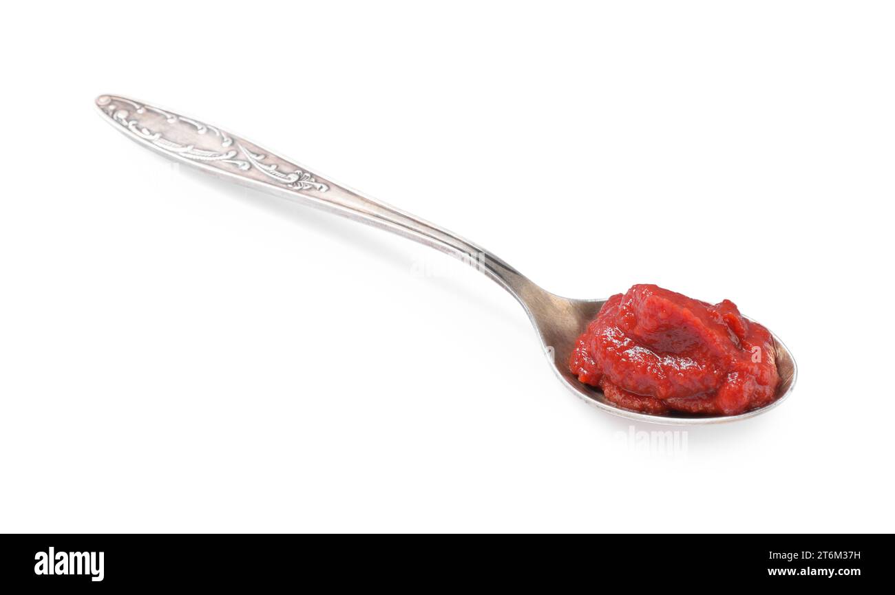 Spoon of tasty tomato paste isolated on white Stock Photo - Alamy