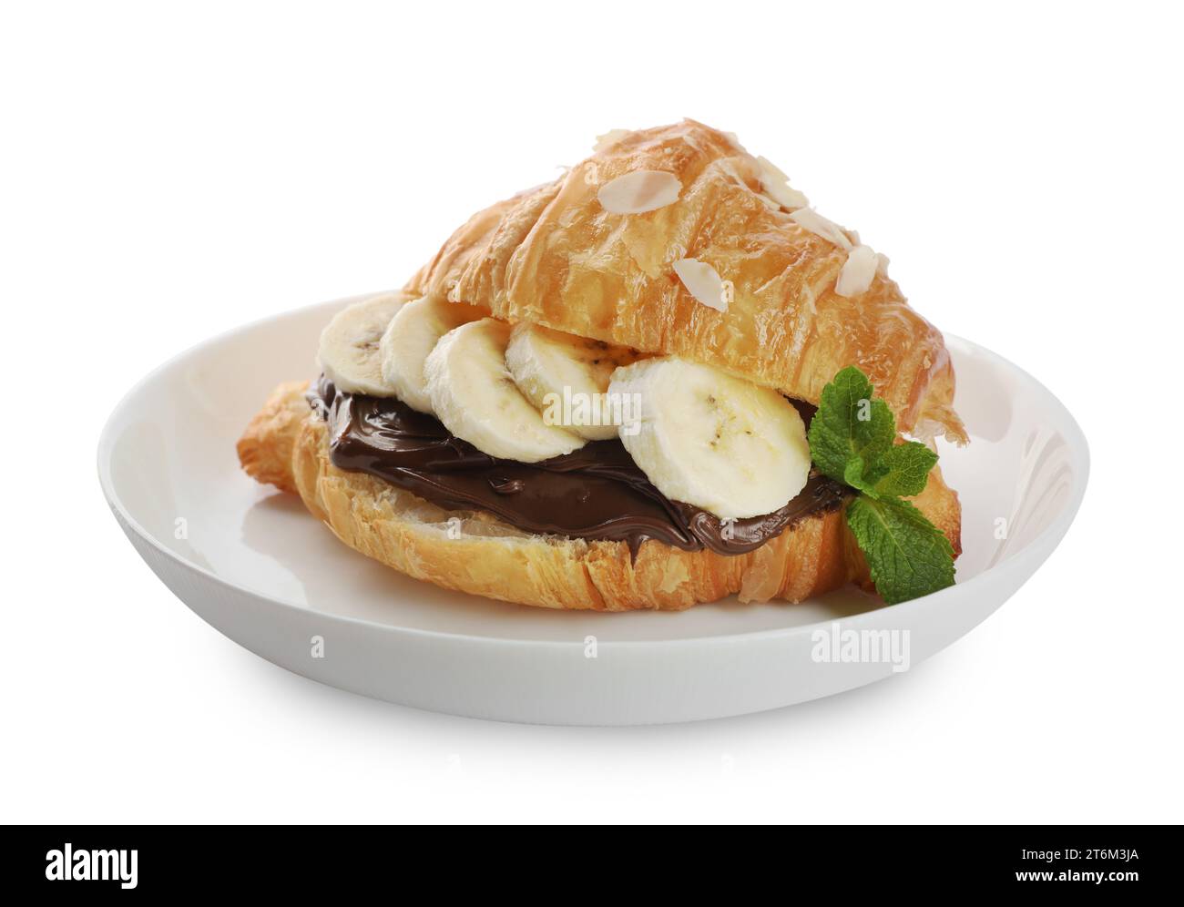 Delicious croissant with banana, chocolate and mint isolated on white ...