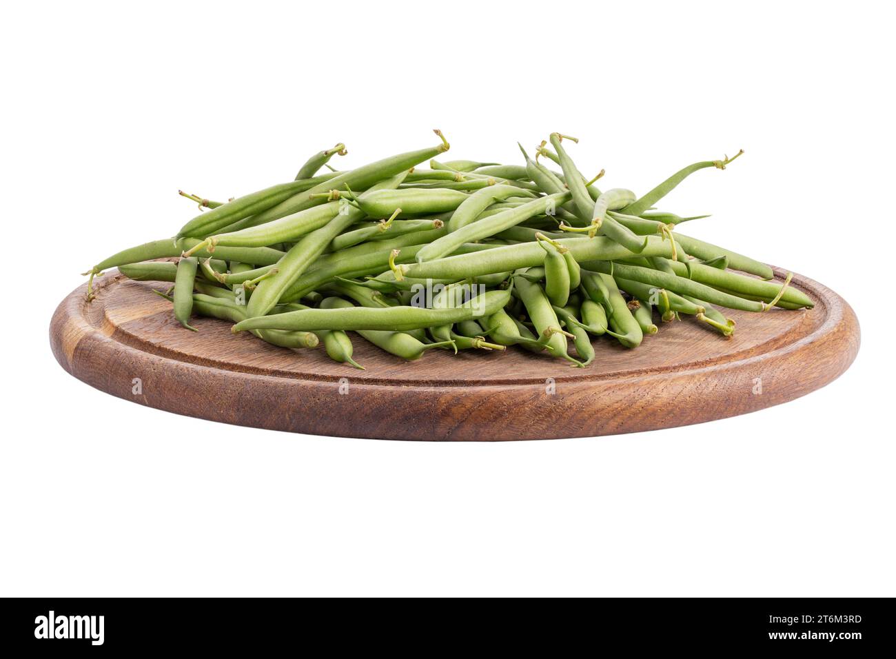 Green beans on a round cutting board isolated on a white background ...