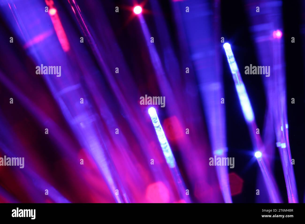 Optical fiber strands transmitting different color lights on black ...
