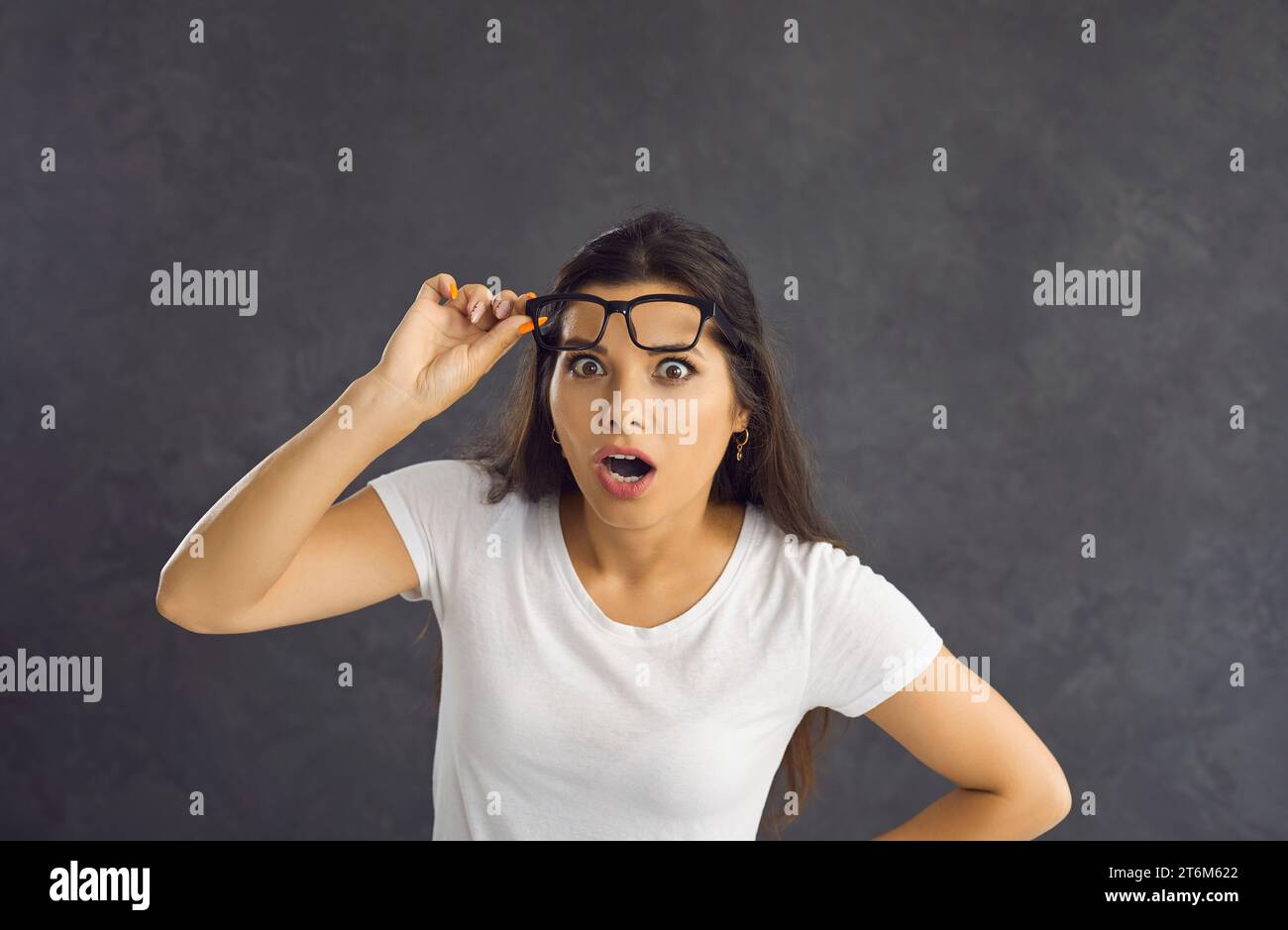 Surprised Woman Takes Off Glasses And Looks At Something With Shocked