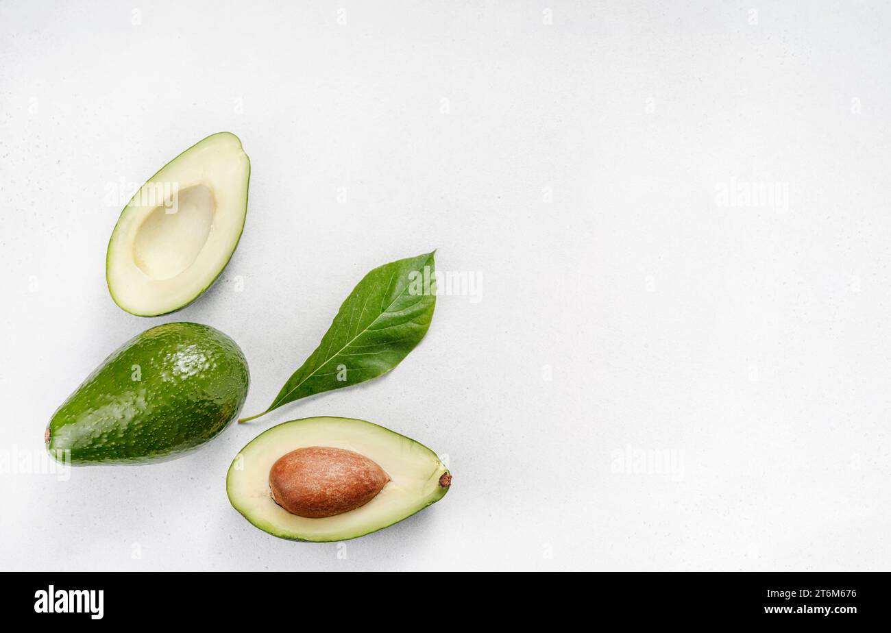Avocado on white background. Halves of raw avocado fruit with avocado ...