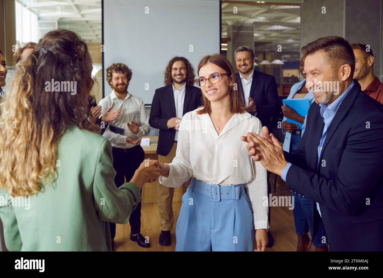 Business colleagues congratulating each other on business achievements ...