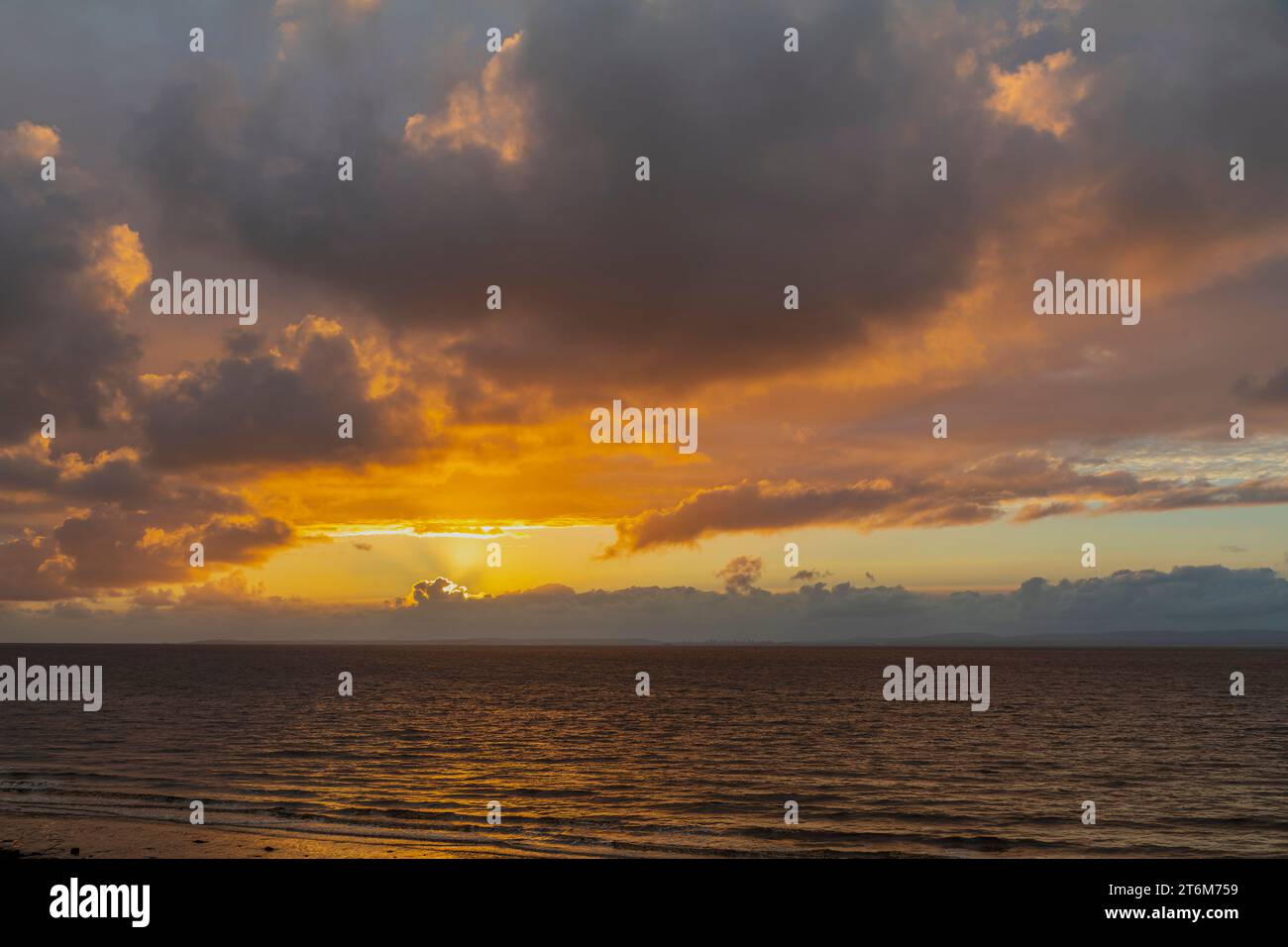 The sun disappearing behind some cloud cover Stock Photo - Alamy