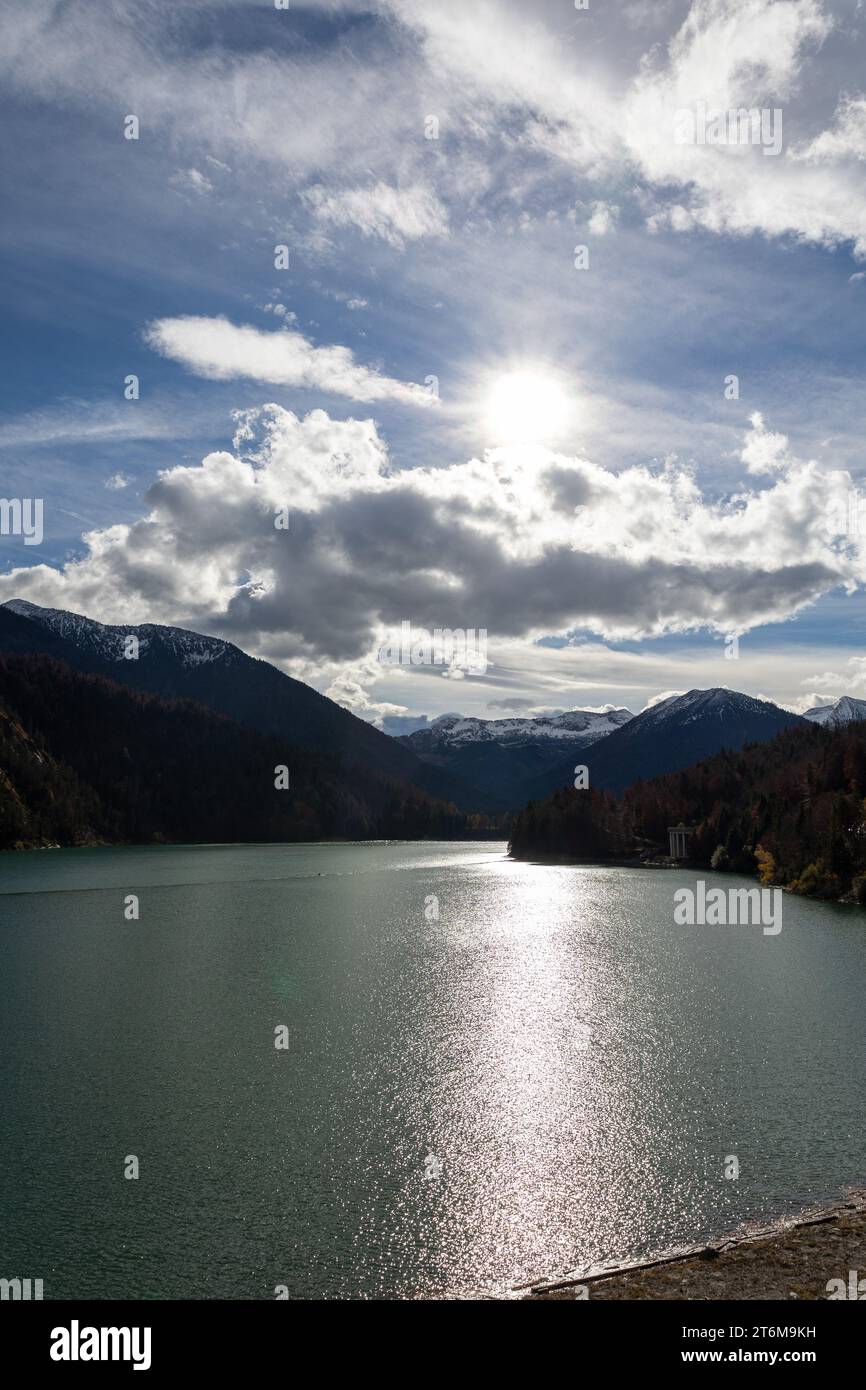 sunshine with cloudy sky above sylvenstein reservoir in german alps and ...