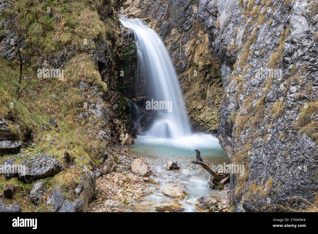 smooth waterfall with white spray flowing down from rock in austrian ...
