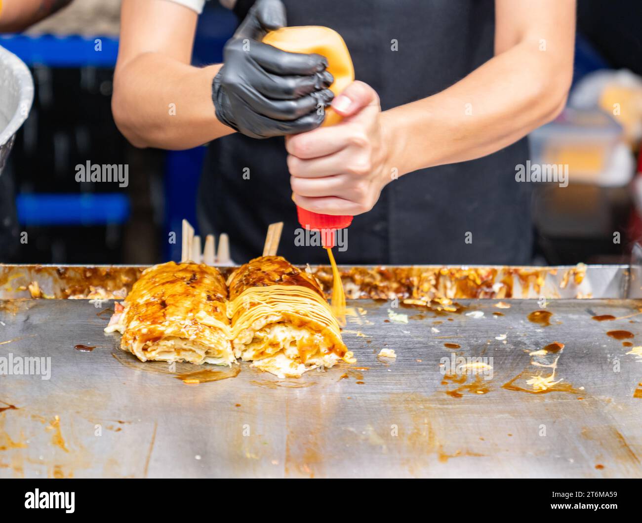 Chef squeeze cheese on Japanese Pizza or Okonomiyaki roll ready to eat ...