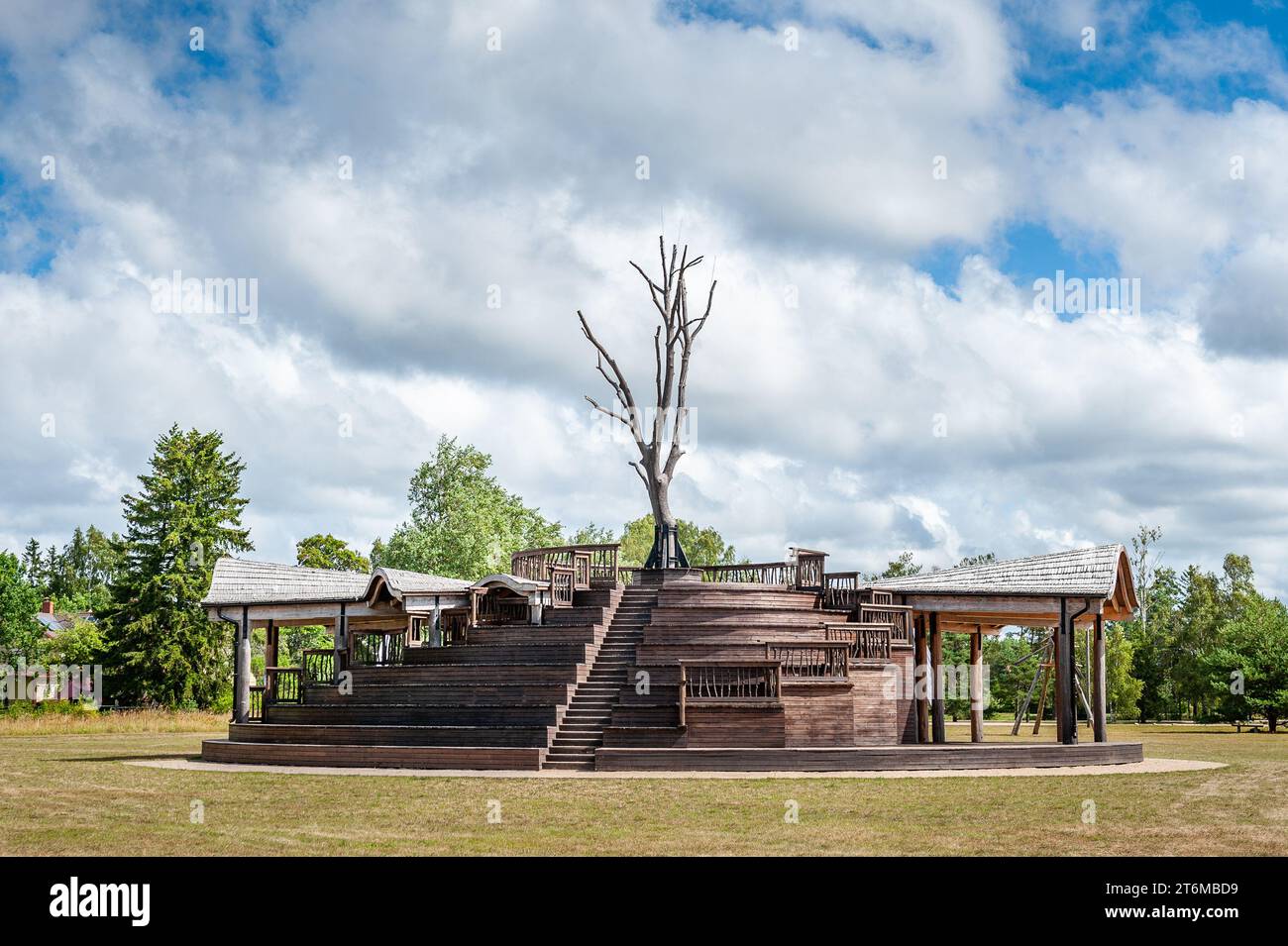 Wooden recreation zone in shape of circles. Round benches in middle of ...
