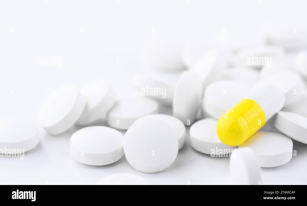 White and yellow medicine tablets antibiotic pills. Pharmaceutical ...