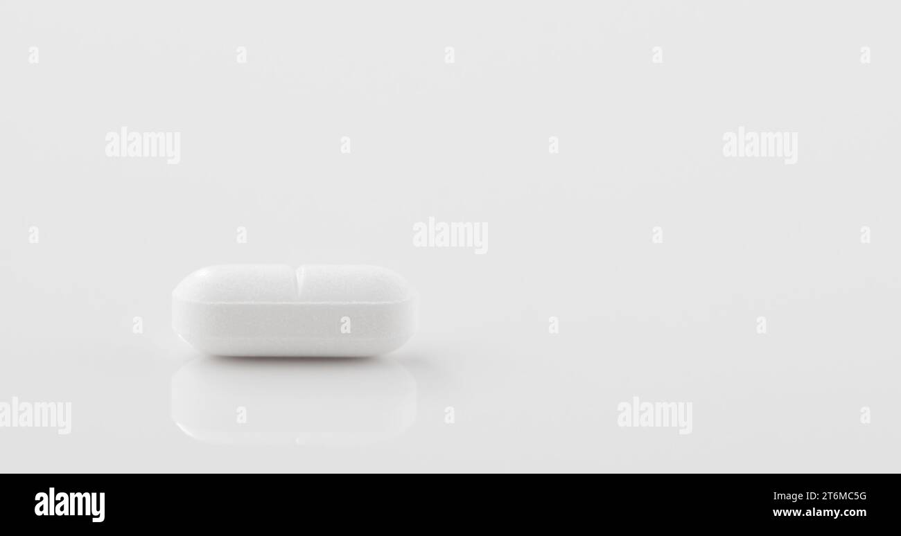 One white pill on a white table. Global healthcare concept Stock Photo ...