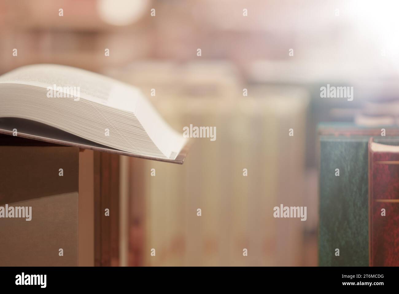 Image of open antique book on stack of books with glitter background ...