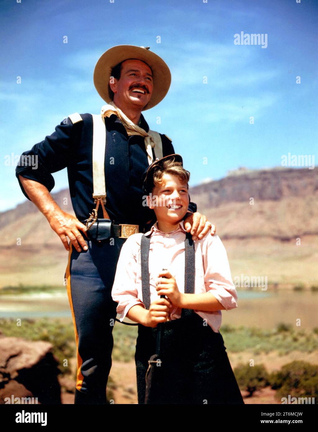 JOHN WAYNE with his son PATRICK WAYNE on set location candid during filming of RIO GRANDE 1950 ...