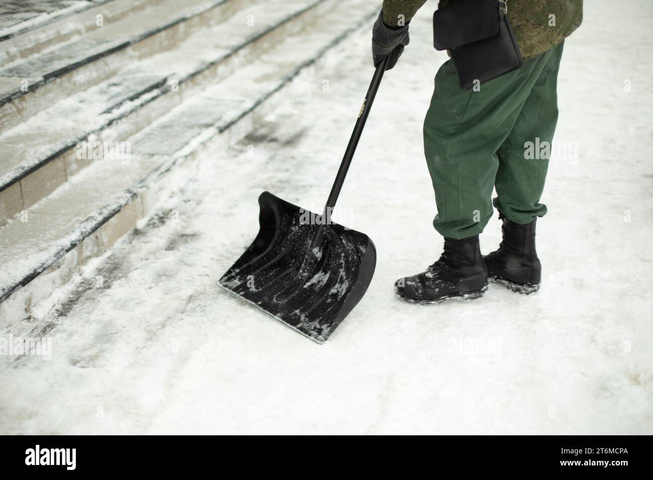 Snow shovel cleaning. Snow in yard in winter. Man cleans path from ...