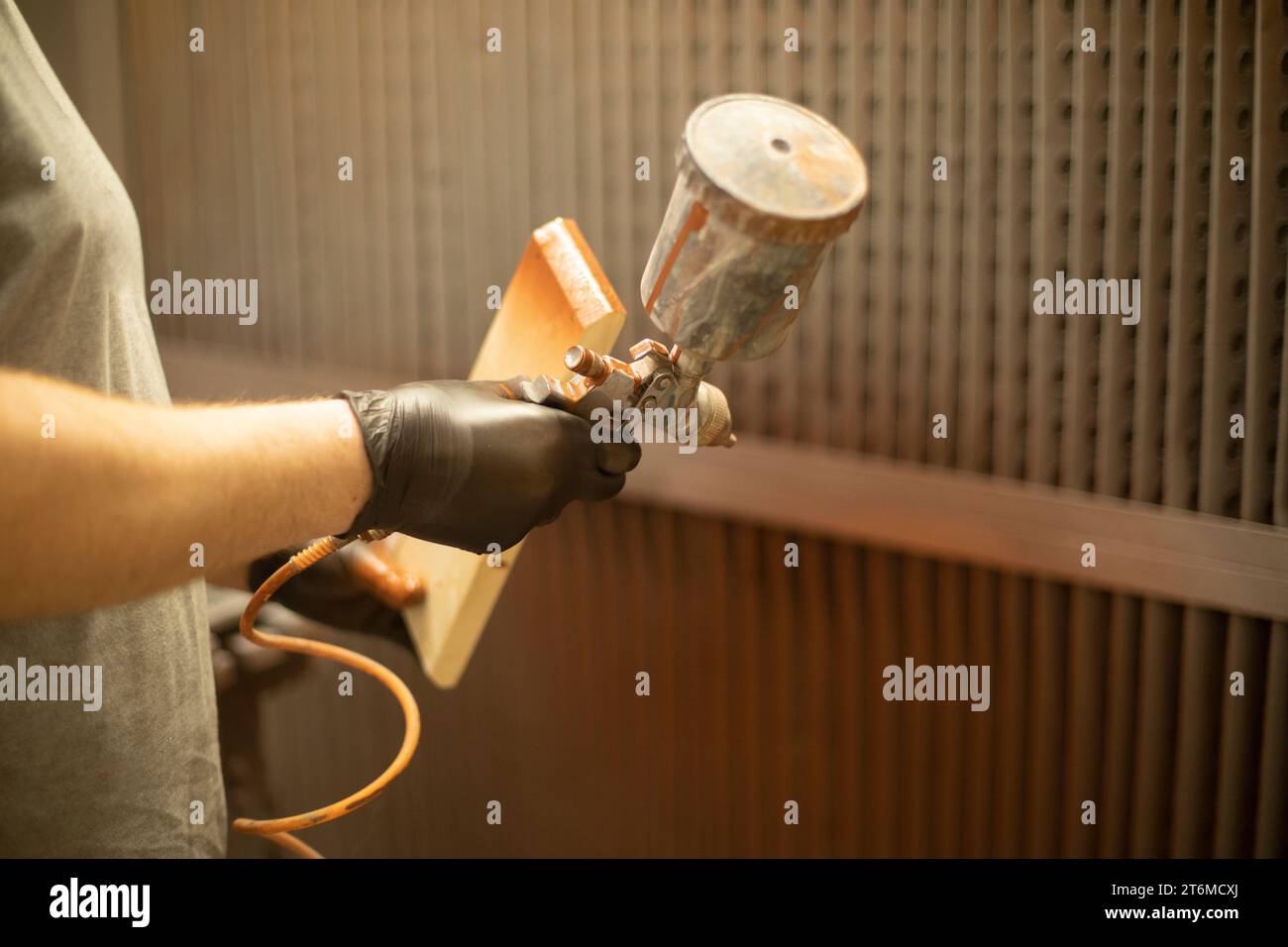 Painting wood. Spray paint. Spray gun in hand. Spray paint under ...