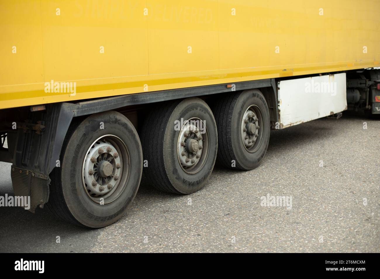 Wheels of truck. Large trailer wheels. Yellow truck trailer. Transport ...