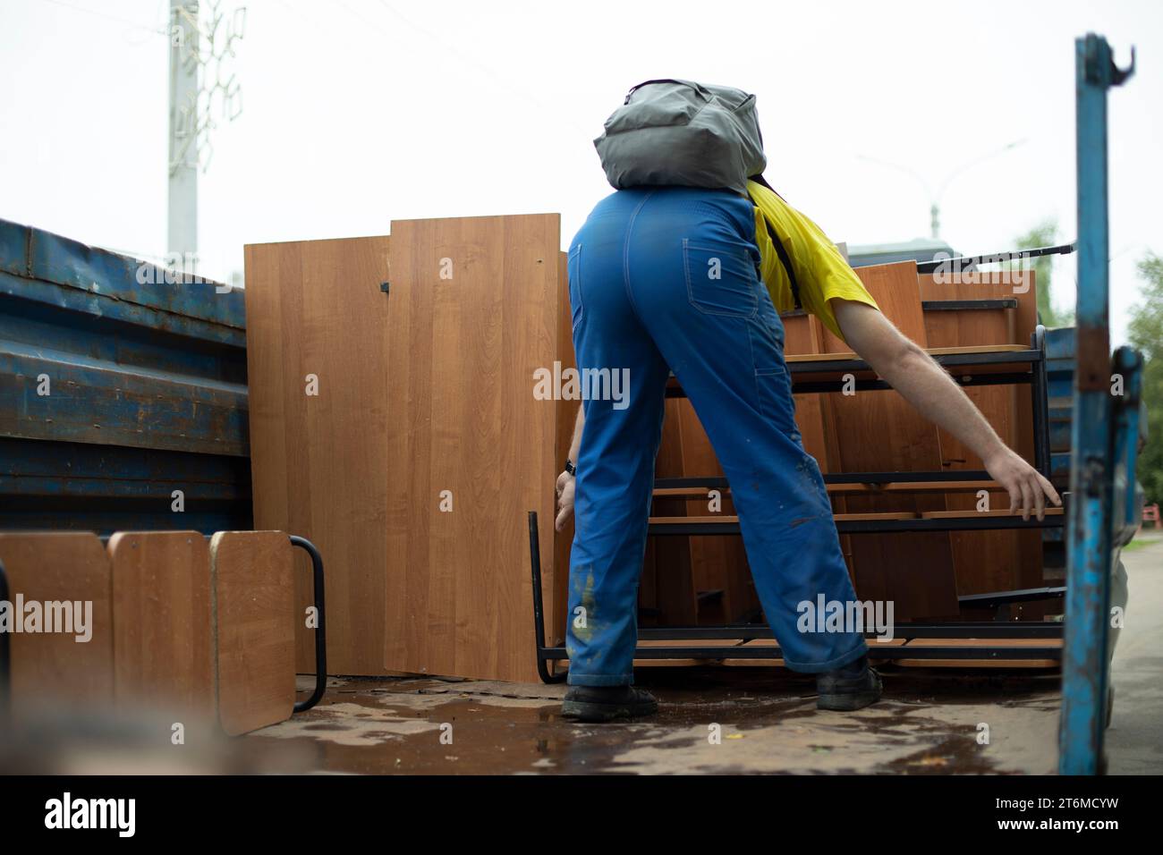 Loader loads furniture into back of truck. Transportation of furniture ...