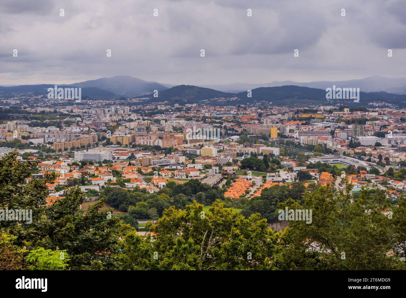 Aerial view of a cityscape from a hilltop, featuring a vibrant skyline ...