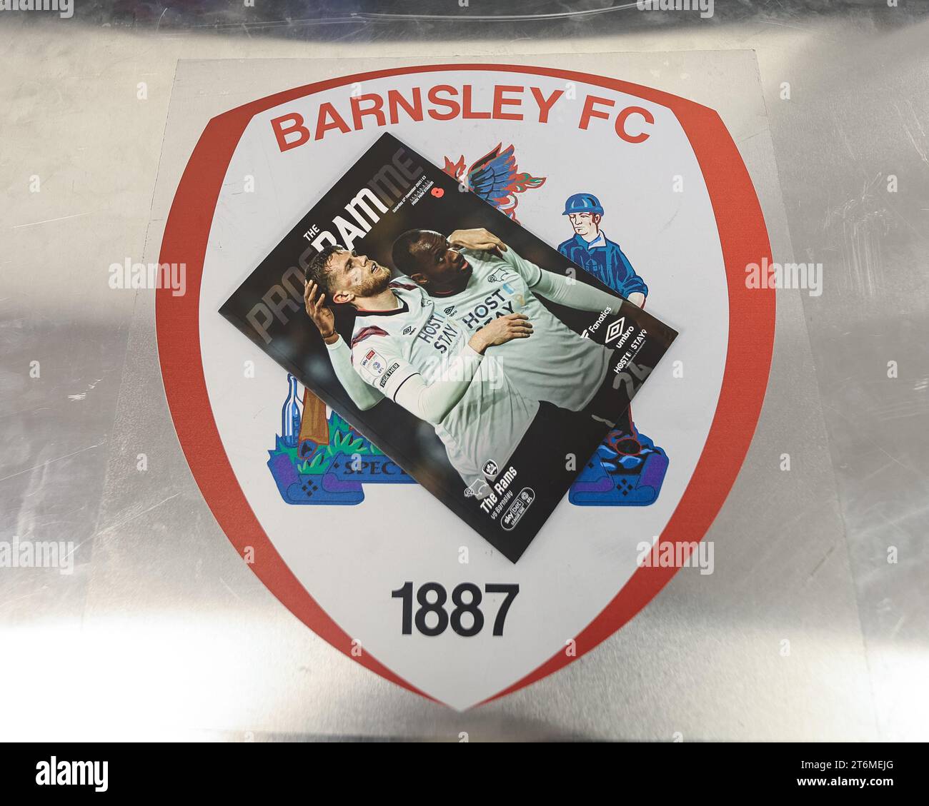 Todays match day program over Barnsley FC badge during the Sky Bet ...