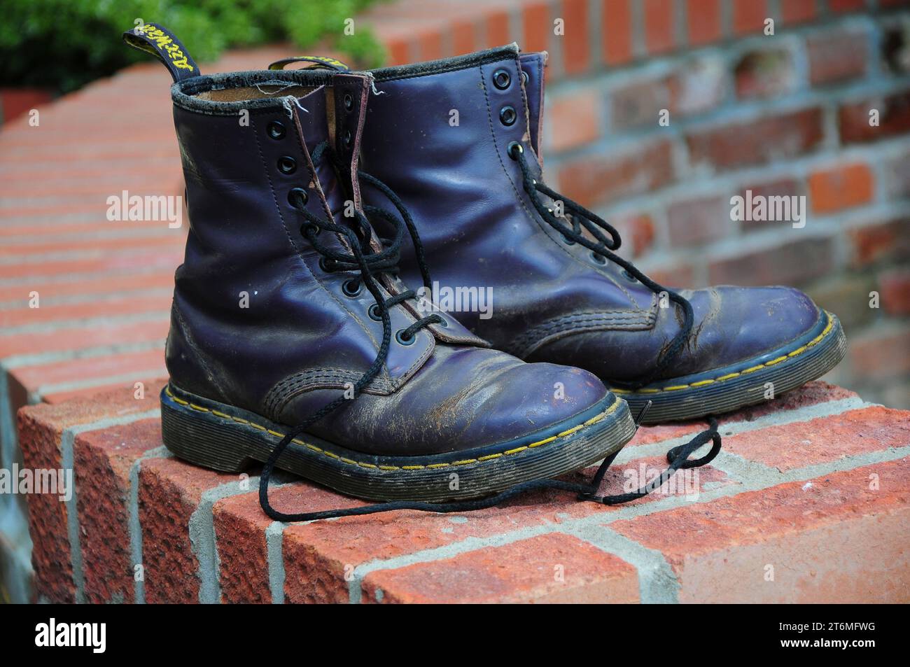 Well worn lace-up work boots Stock Photo - Alamy