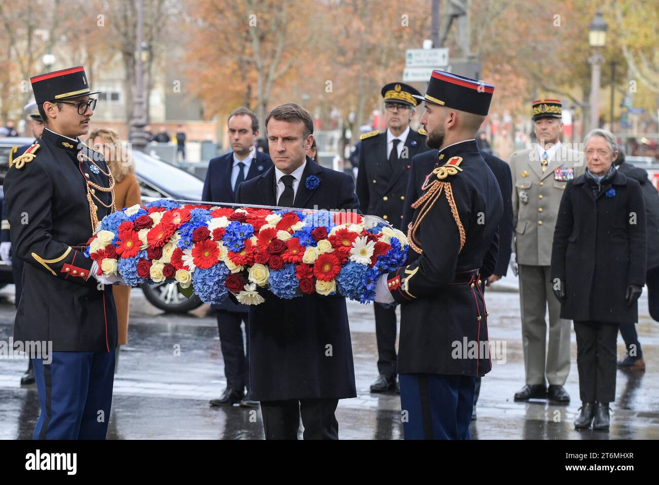 French President Emmanuel Macron lays a wreath of flowers during a ...