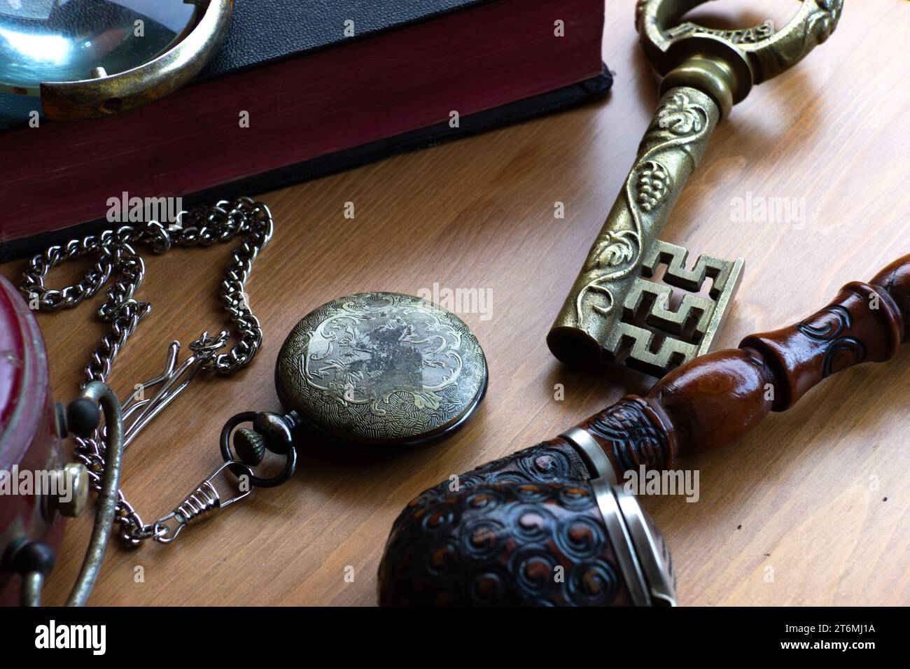 Vintage still life. Old pocket watch, antique key, smoking pipe and ...