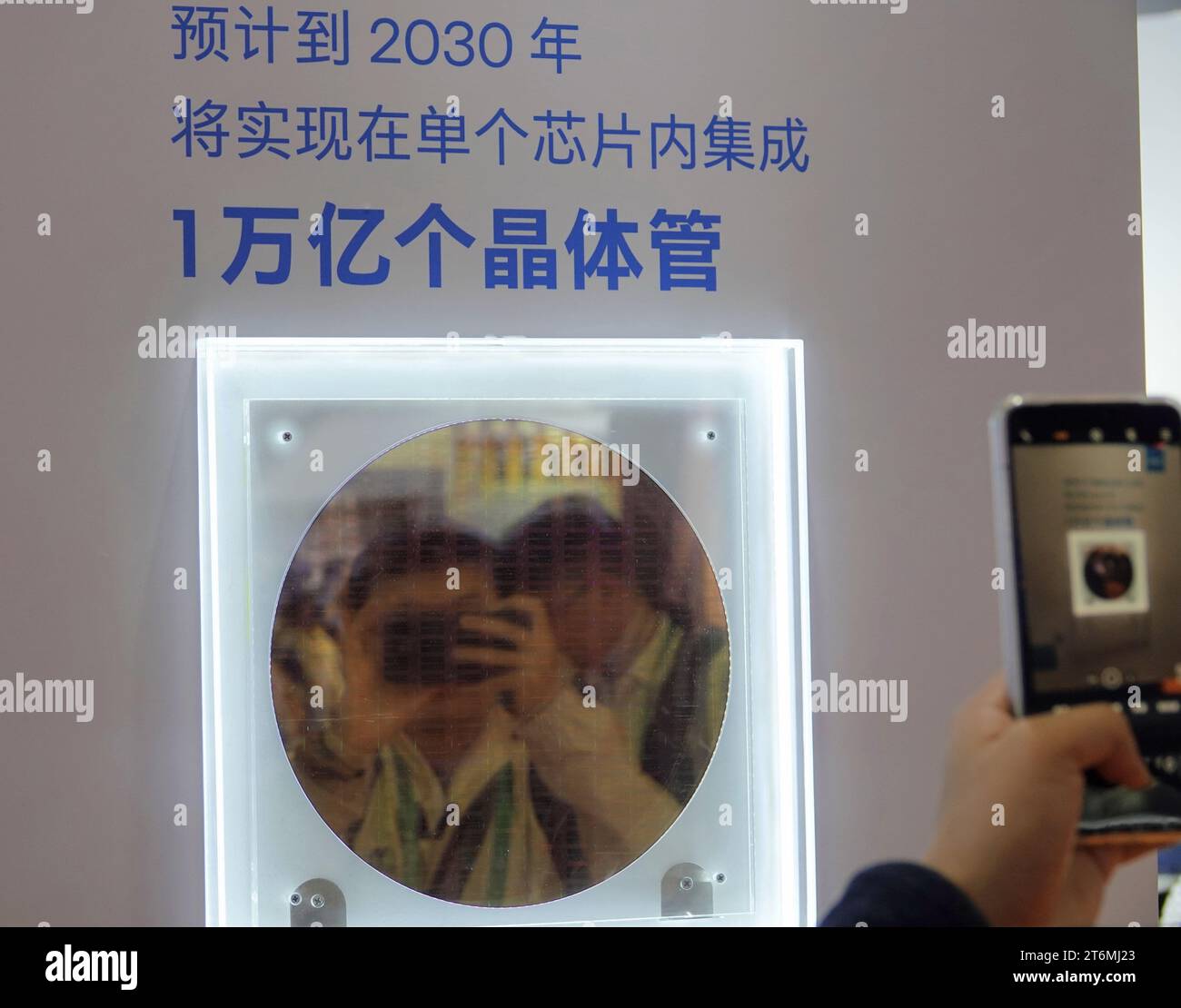 SHANGHAI, CHINA - NOVEMBER 8, 2023 - Visitors take photos of a wafer ...