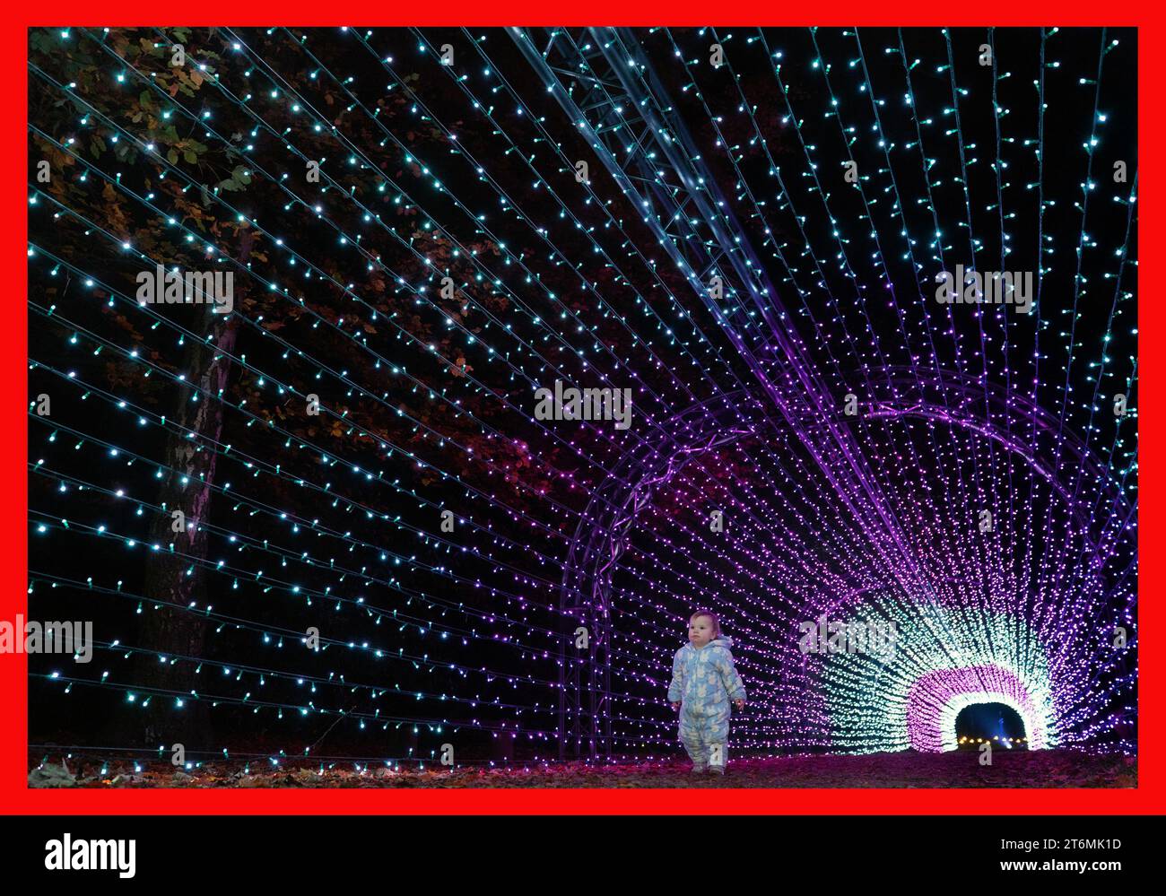 One-year-old Summer enjoys walking through a light installation during ...