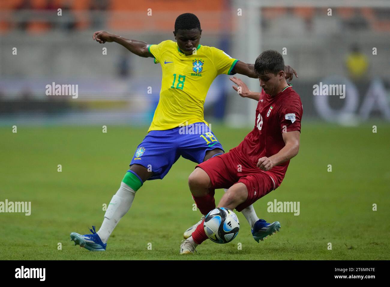 Iran's Mahan Sadeghi, right, battles for the ball against Brazil's ...