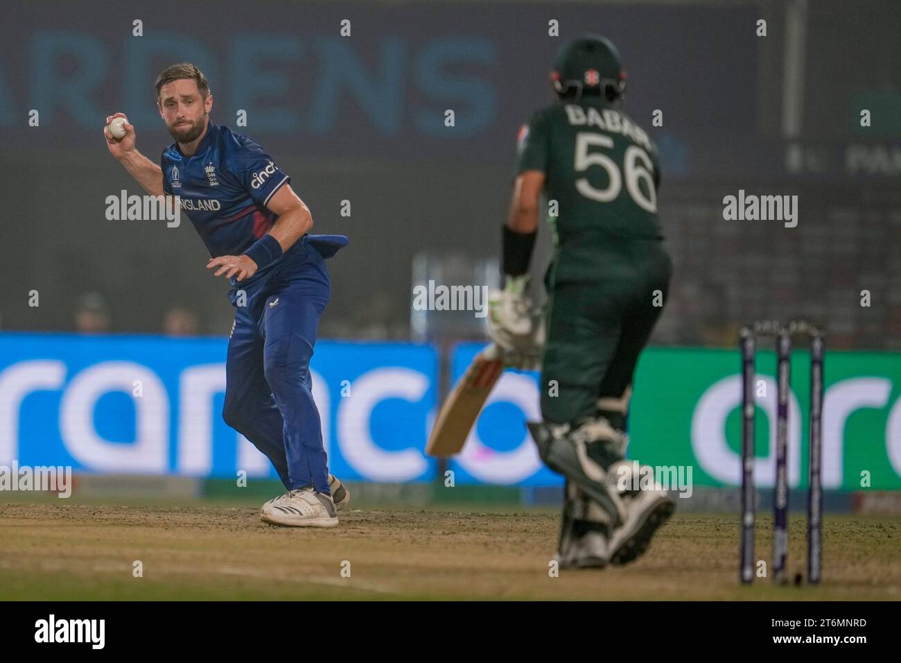 England's Chris Woakes, left, tries to throw the ball at stumps after ...