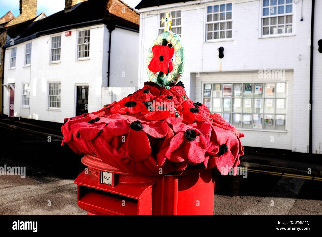 red post box with commemorative red felt poppys adorning Stock Photo ...