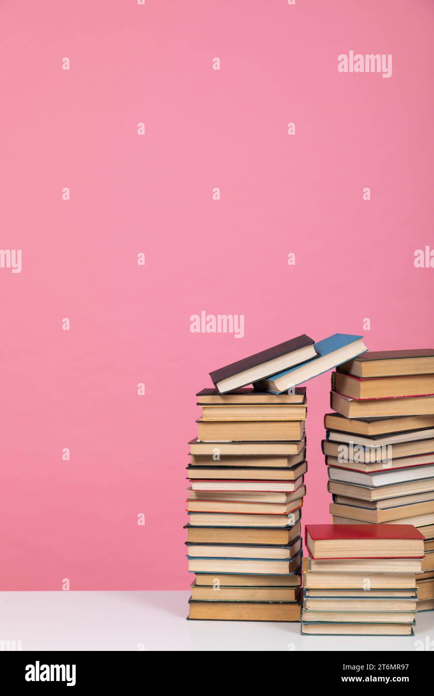 science education stack of books on pink background literacy training ...