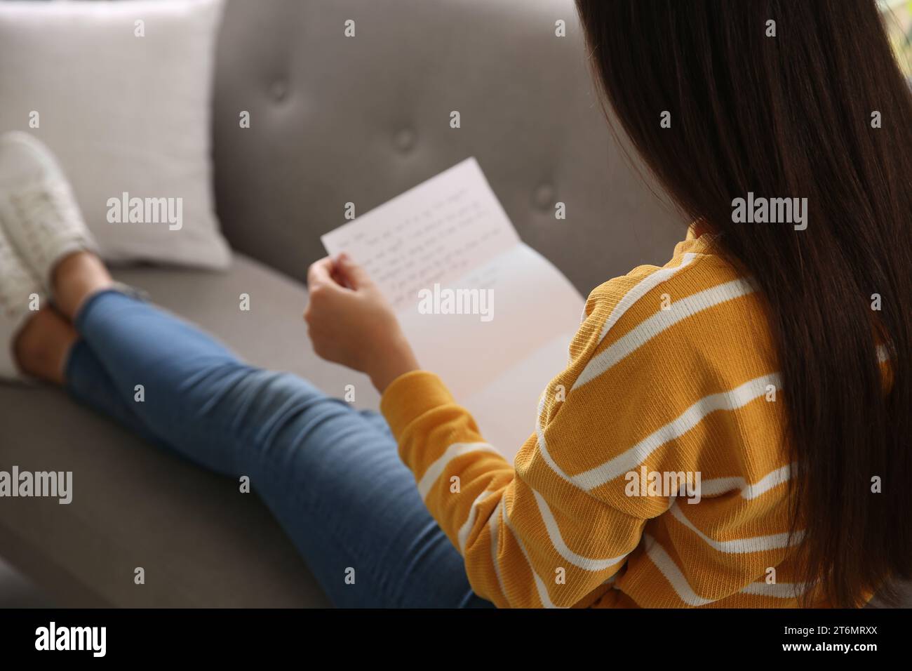 Woman reading letter on sofa at home, closeup Stock Photo - Alamy