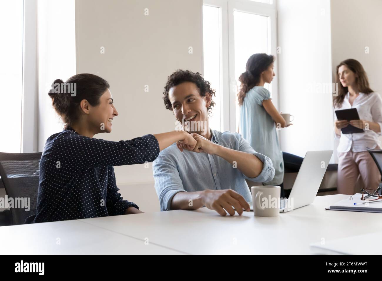 Two cheerful office friends celebrating business task completion Stock ...