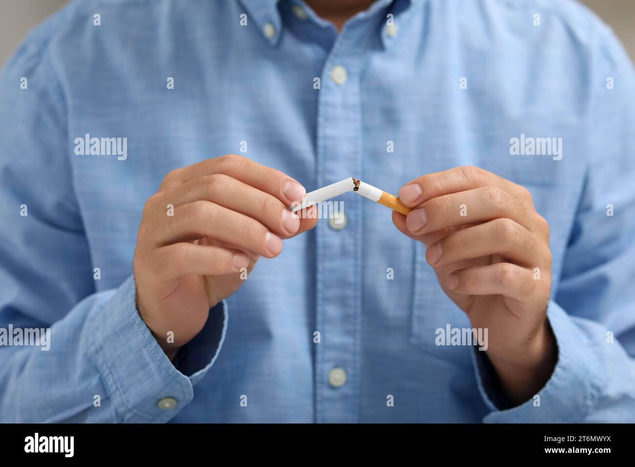 Stop smoking concept. Man breaking cigarette, closeup Stock Photo - Alamy