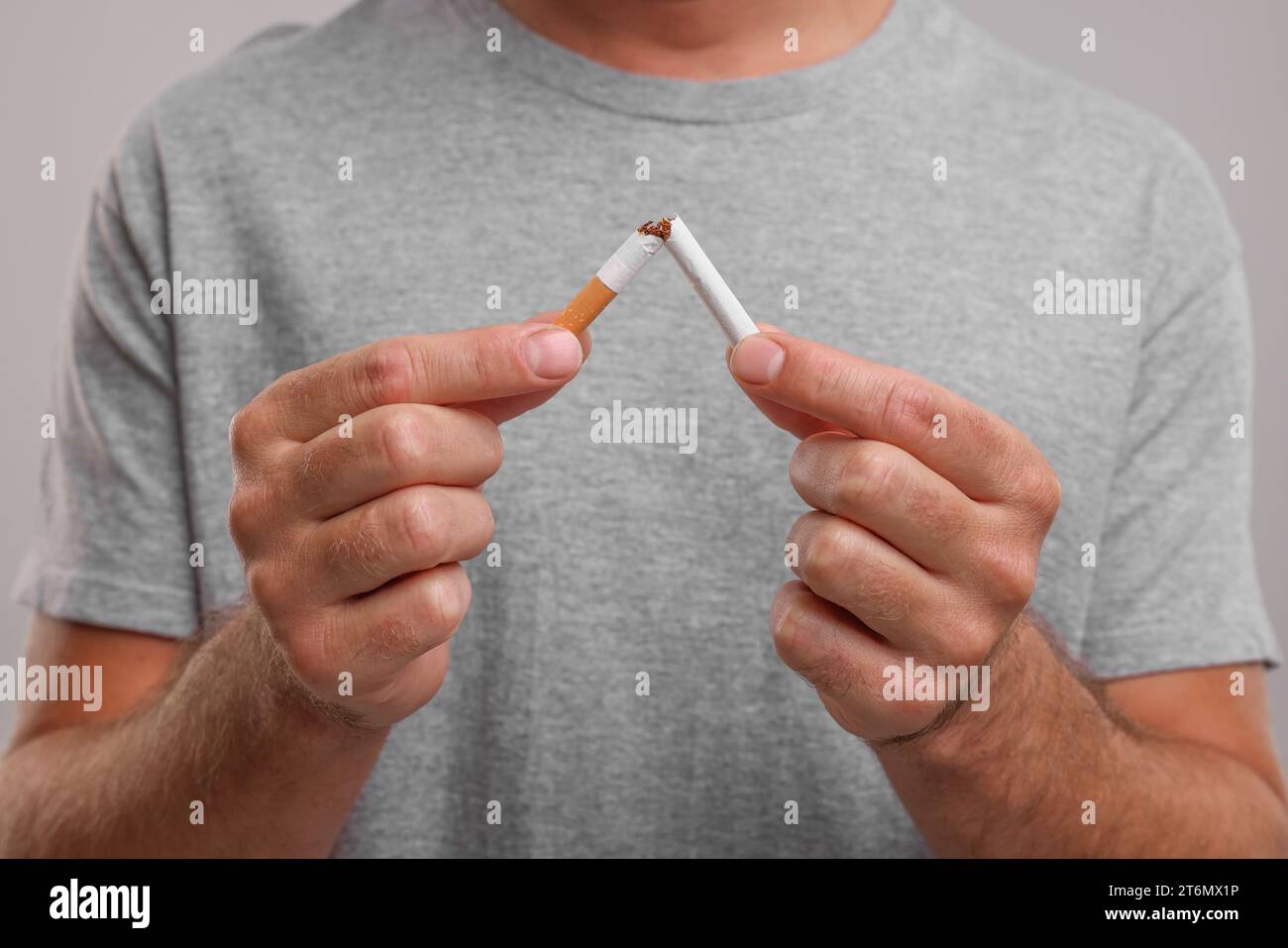 Stop smoking concept. Man breaking cigarette, closeup Stock Photo - Alamy