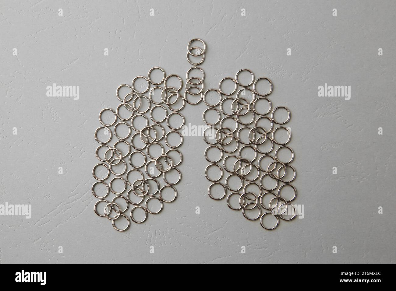 Human lungs made of metal rings on grey textured table, flat lay Stock ...