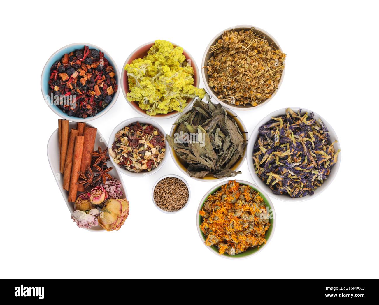 Many different dry herbs, flowers and spices in bowls isolated on white ...