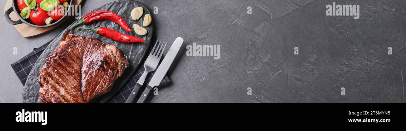 Delicious fried beef meat served on grey table, flat lay. Banner design ...