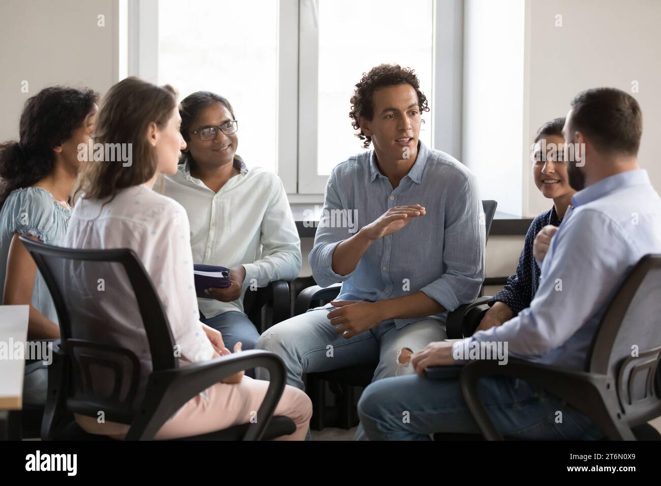 Motivated inspired business team employee man talking to colleague ...