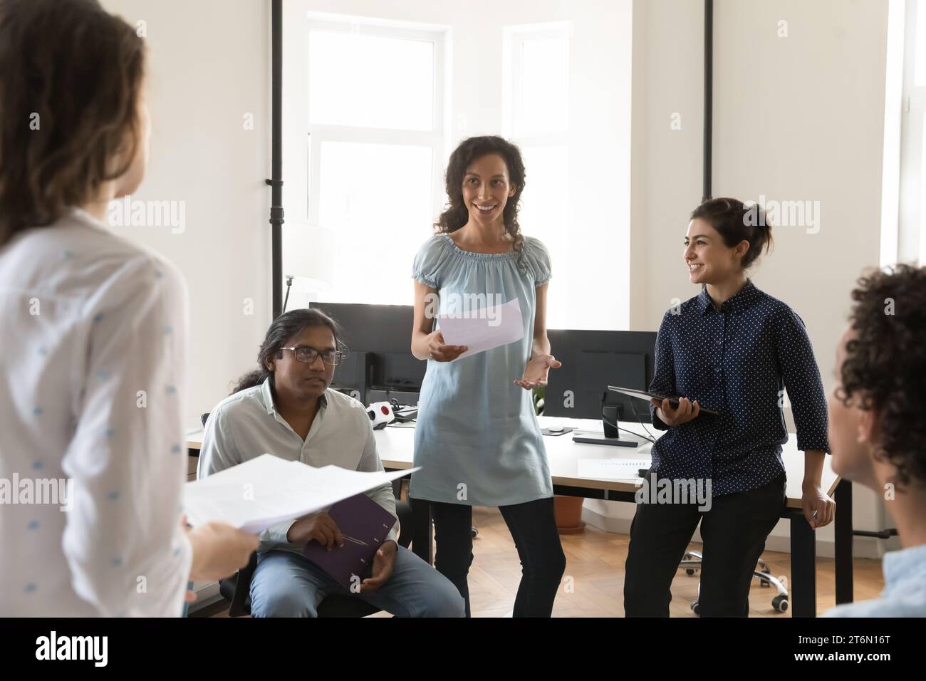 Happy motivated multiethnic business colleagues women speaking at team ...