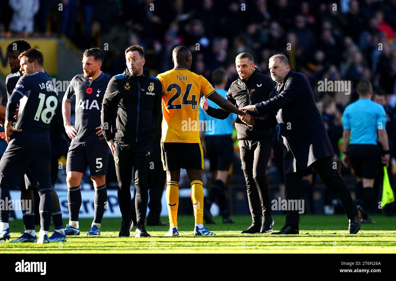 Tottenham Hotspur manager Ange Postecoglou (right) shake hands with ...