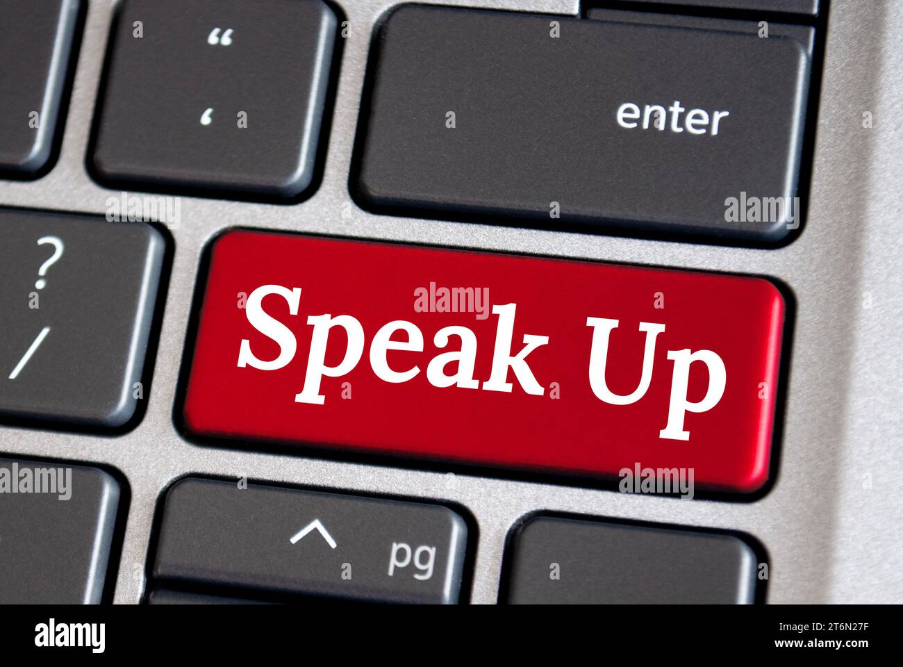Speak up text on red color laptop keyboard. Courage to speak up concept ...