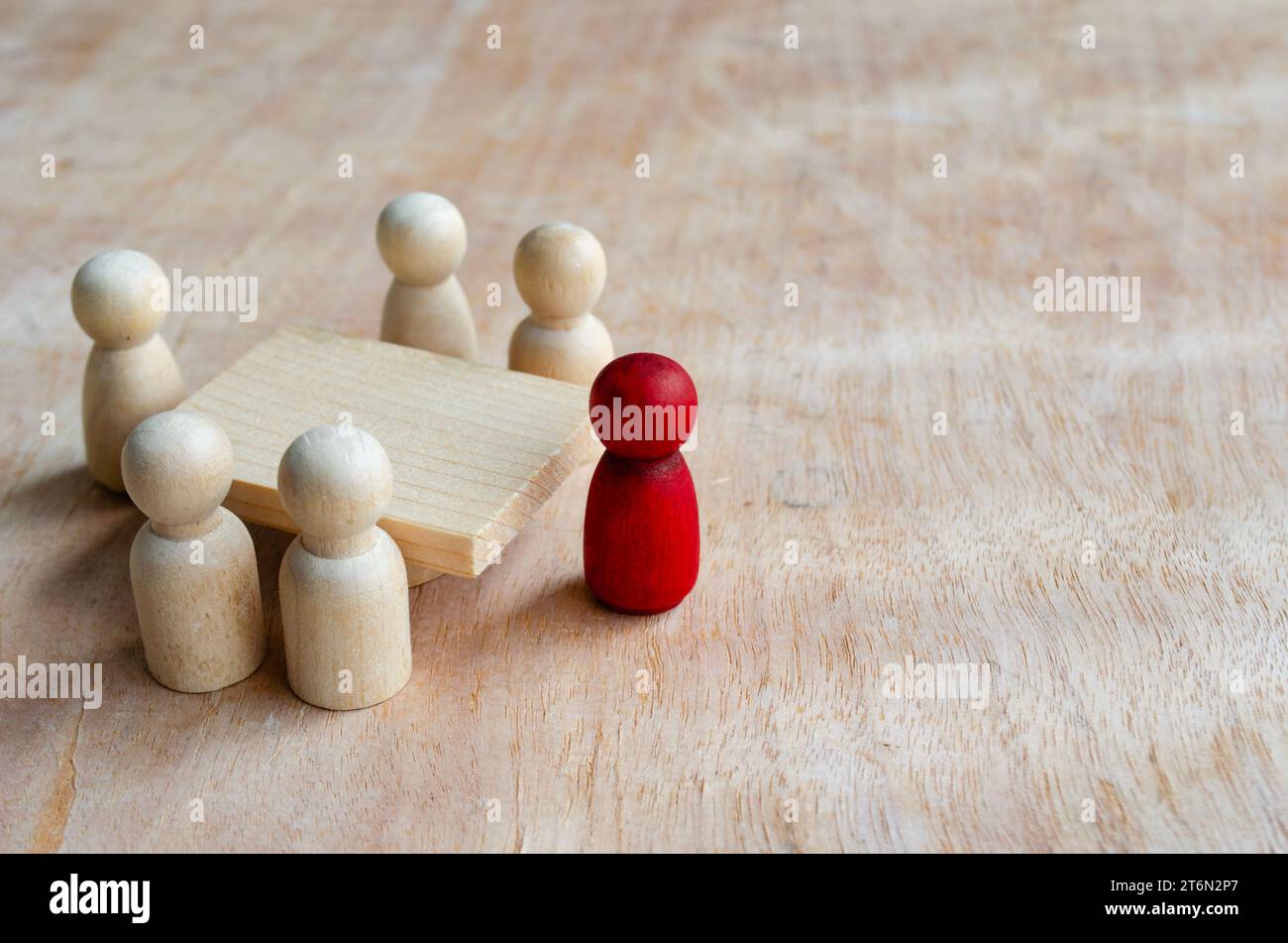 Red wooden figure leading the meeting or discussion. Meeting or ...