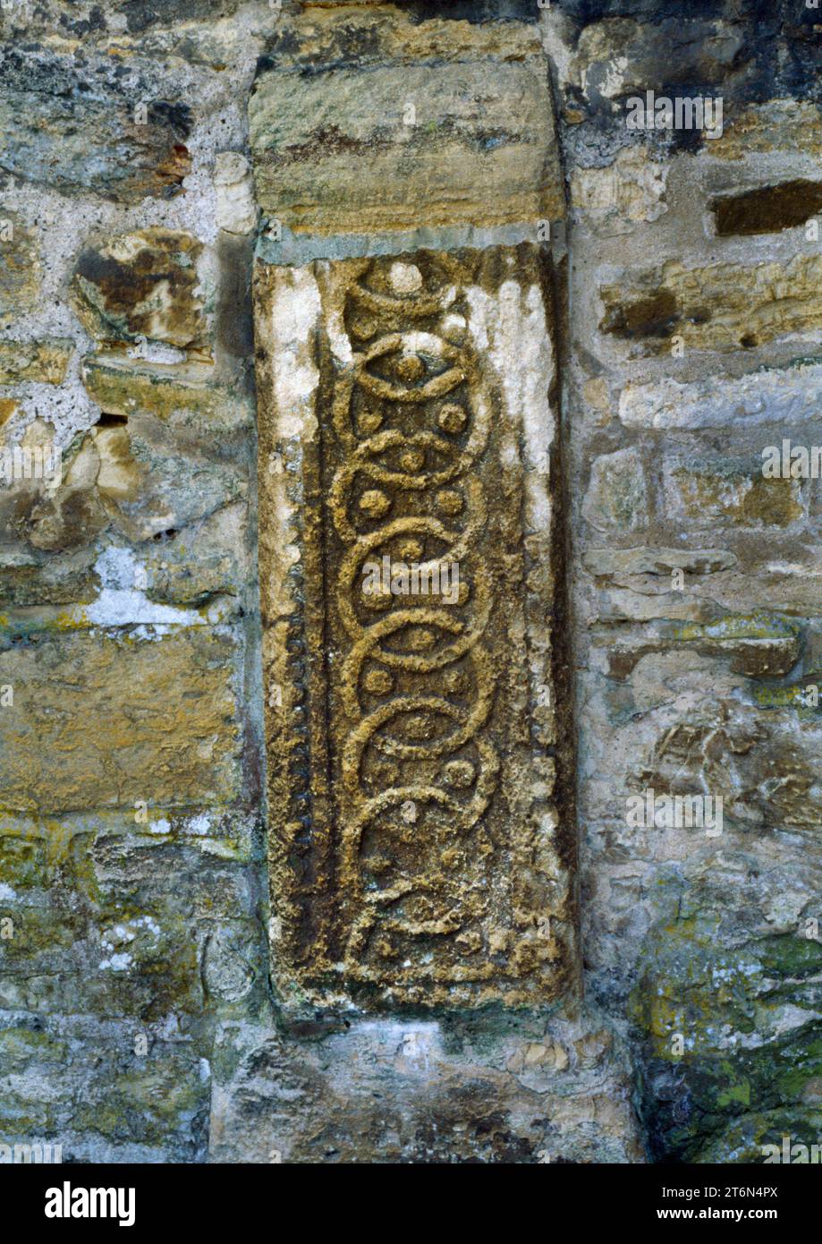 An Anglo-Saxon gravestone re-set into a buttress on the external N wall ...