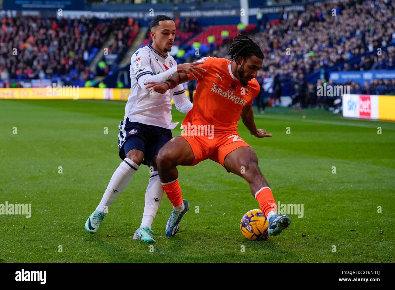Josh Dacres-Cogley #12 of Bolton Wanderers competes for the ball with ...