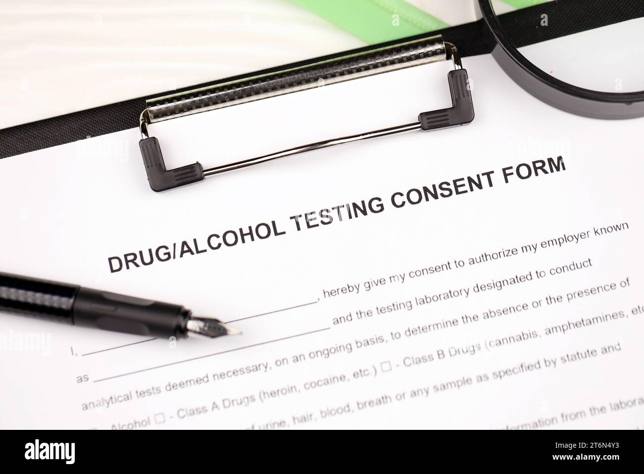 Drug and alcohol testing consent form on A4 tablet lies on office table ...