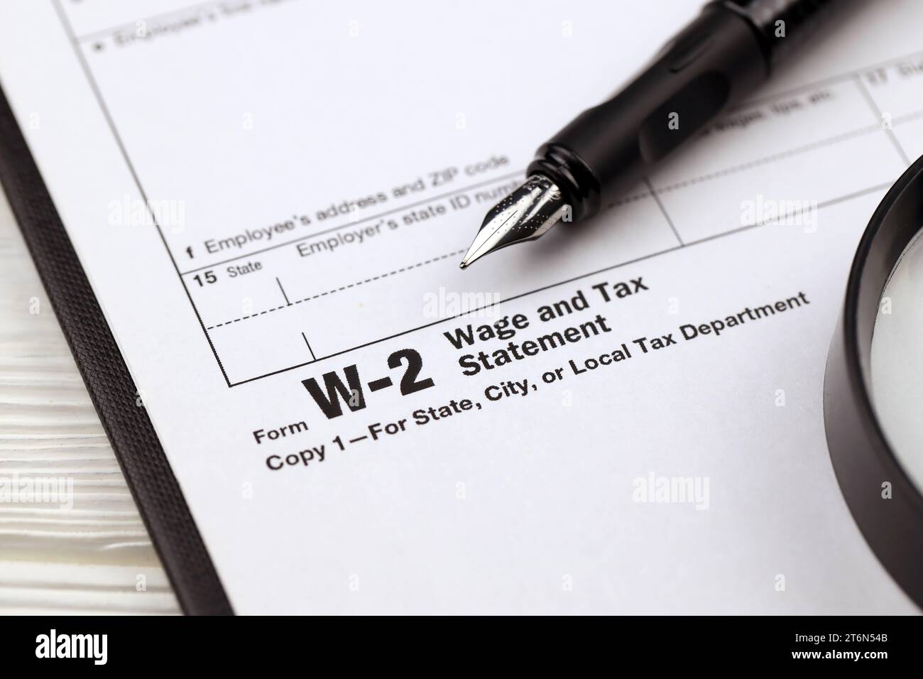 IRS Form W-2 Wage and Tax Statement blank on A4 tablet lies on office ...