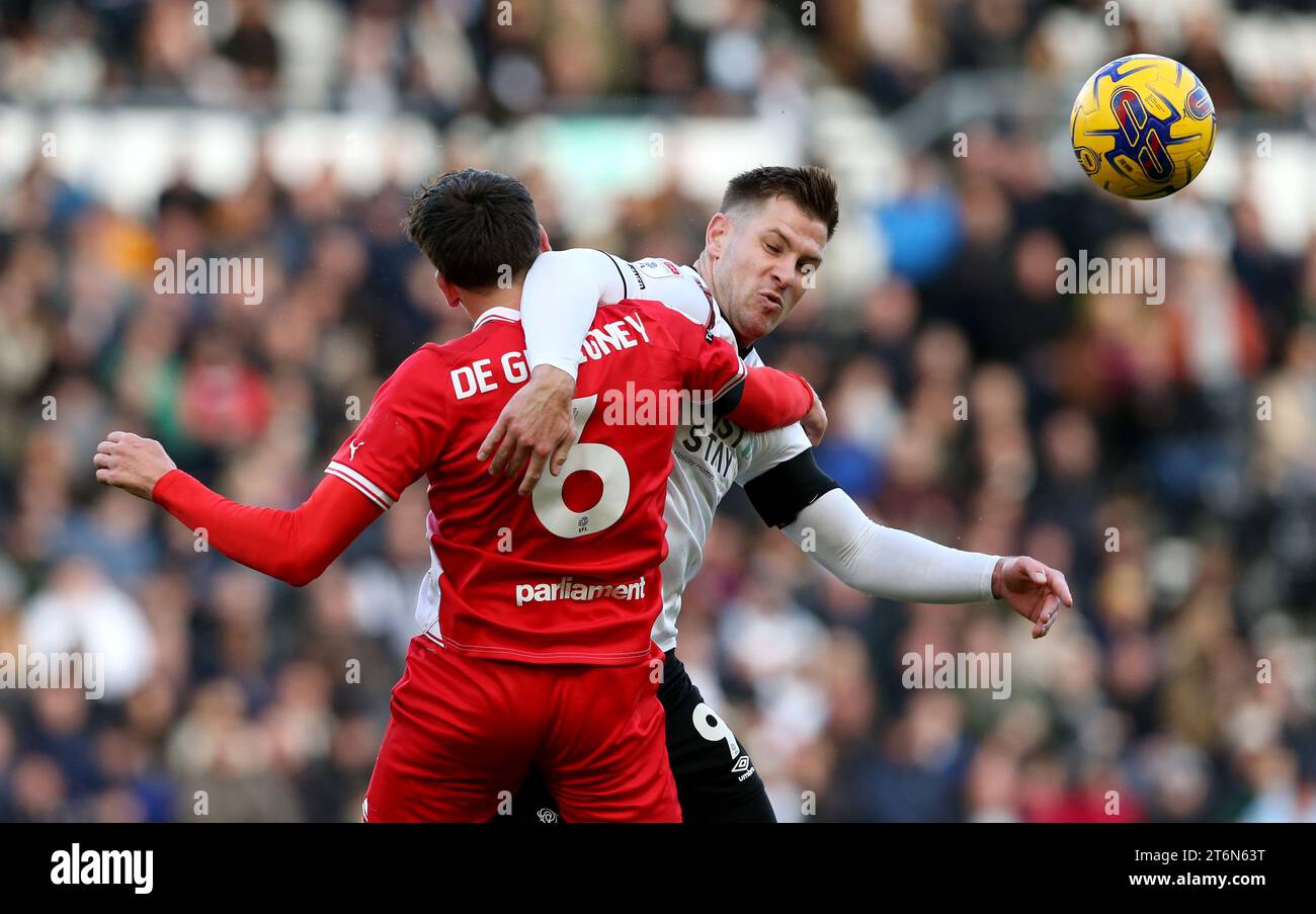 Barnsley's Mael Durand de Gevigney (left) and Derby County's James ...